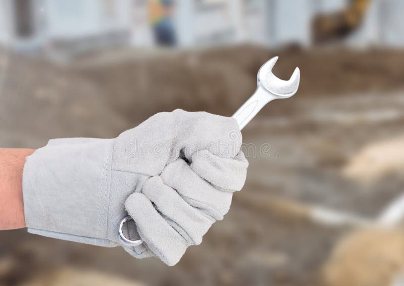 Hand with Spanner on Building Site Stock Image - Image of blue ...