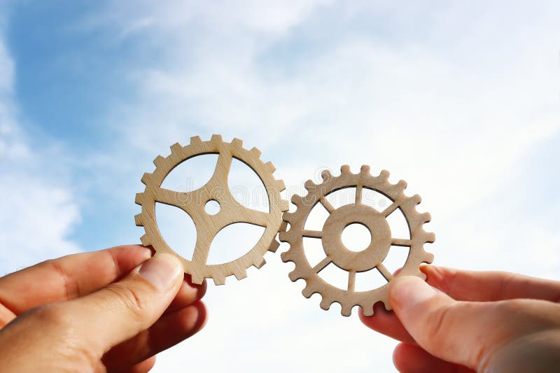 Hand Spinning Gears in Front of Sky Stock Photo - Image of mechanical ...