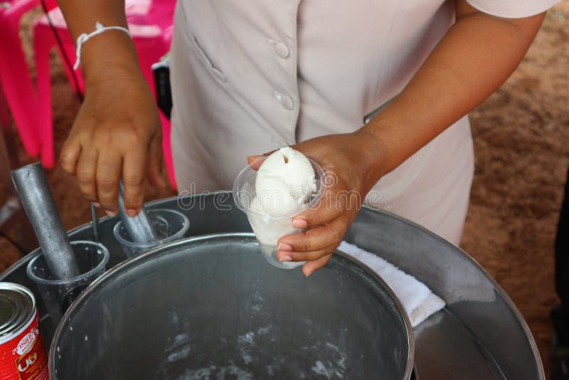 The Hand is Spinning Milk Ice Cream in a Bucket. Stock Image - Image of ...