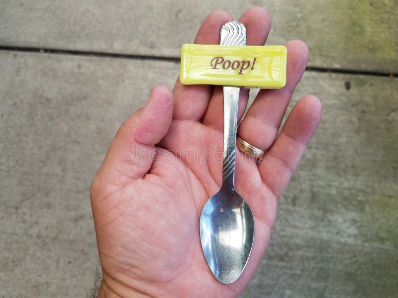 Hand with Spoon and Poop Sign and Gold Ring Stock Photo - Image of sign ...
