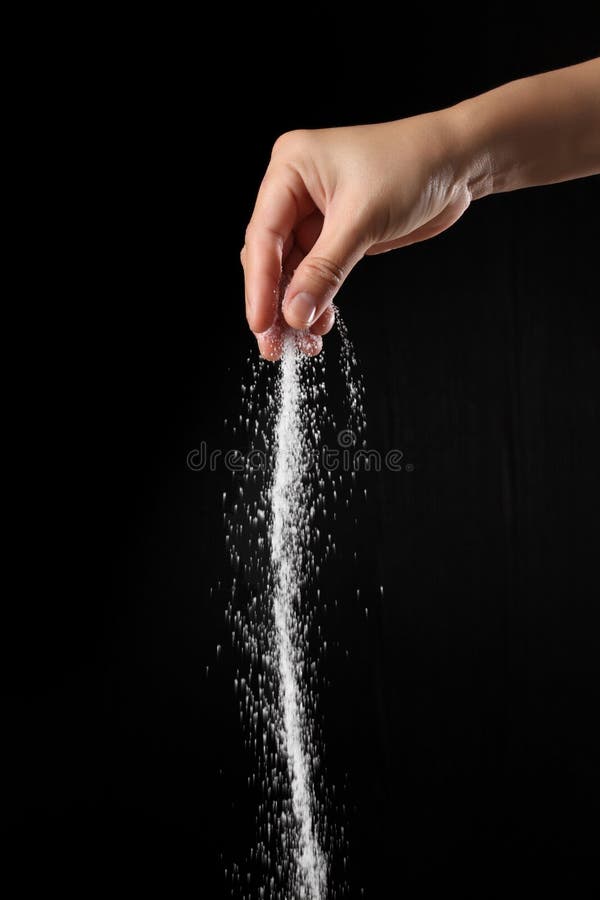 Hand Sprinkling Brown Sugar on Black Background Stock Image - Image of ...