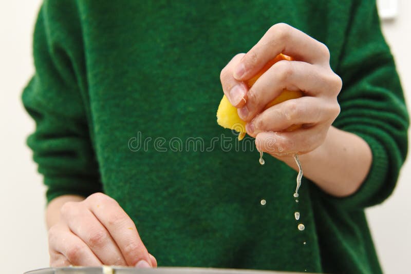 Hand Squeezes the Juice from a Sliced Lemon Stock Photo - Image of ...