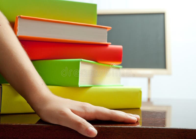Hand and Stack of Colored Book on the Table Stock Photo - Image of girl ...