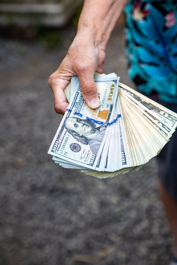 Hand with stack of money stock image. Image of cash - 257901253