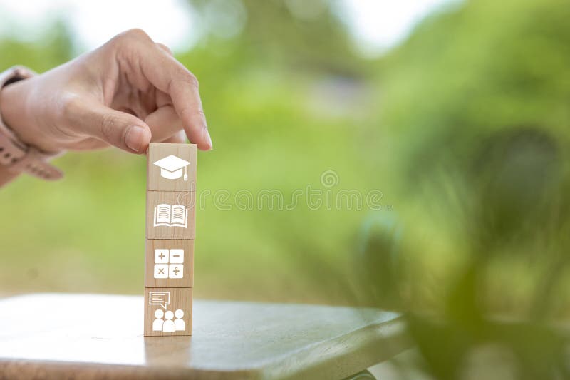 Hand Stacking Wooden Blocks with Icons Representing Education Stock ...