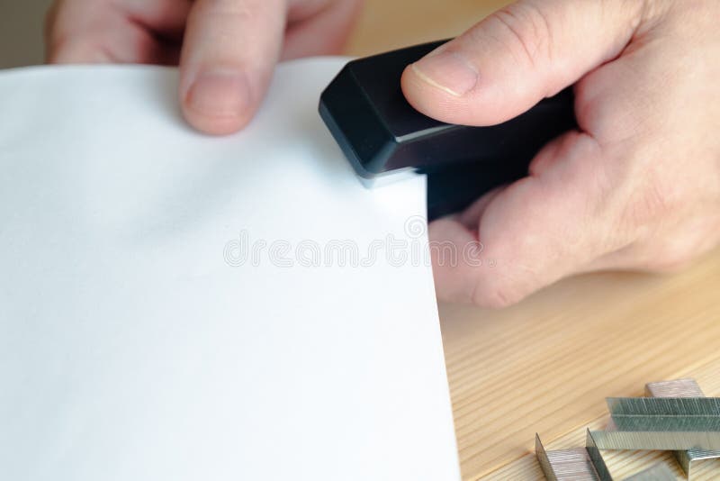 The Hand with a Stapler Connects the Documents Copy Space Stock Photo ...