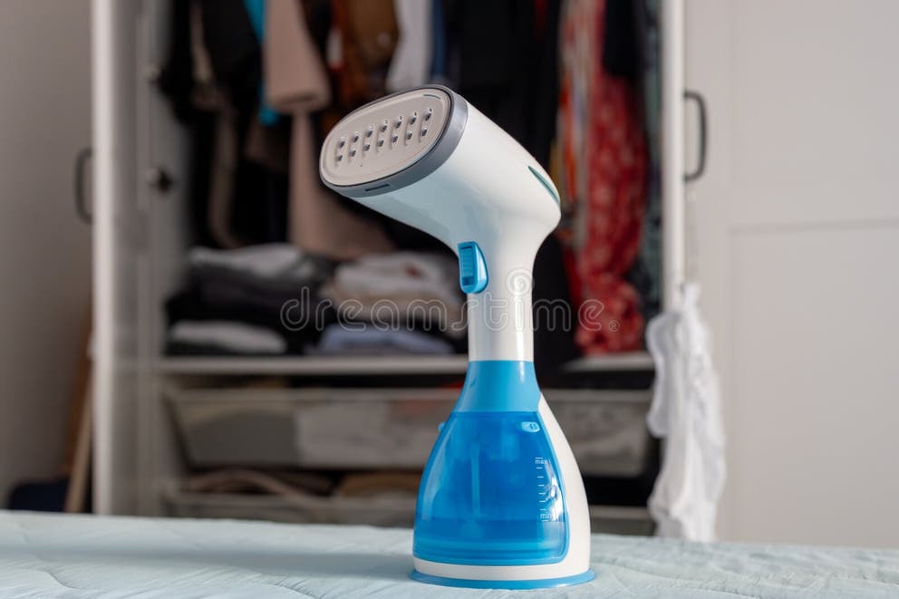 Hand Steamer in Front of an Open Wardrobe Full of Clothes Stock Photo ...
