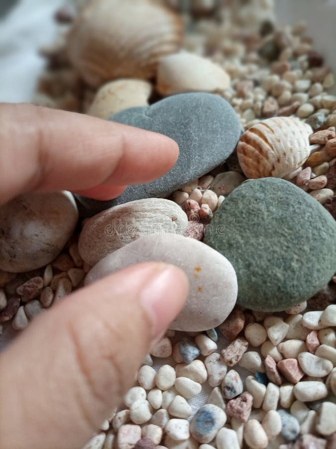 Hand and stocked stones stock photo. Image of stones - 211283196