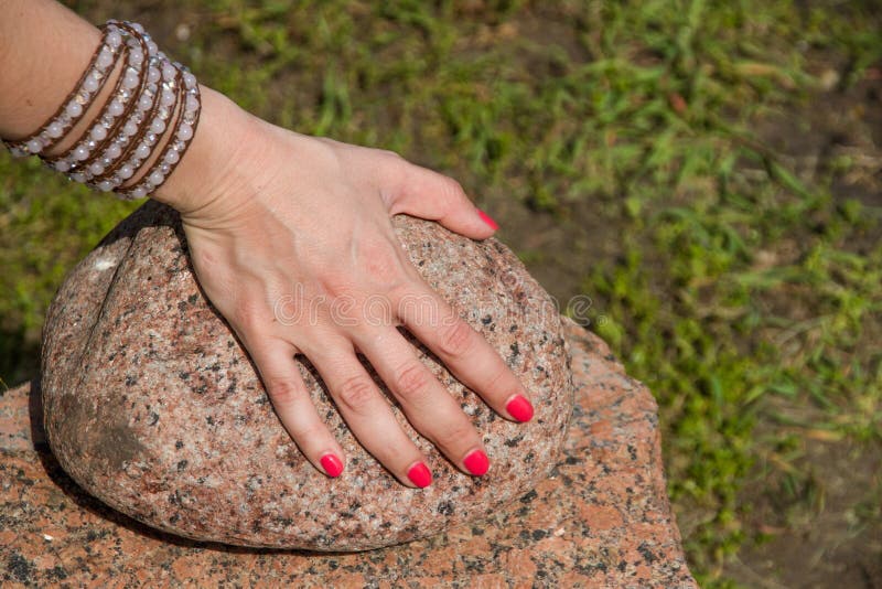 The hand on the stone stock photo. Image of lawn, stone - 71913410