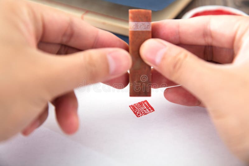 Hand the Stone Seal on the White Pape Stock Image - Image of hand, clay ...