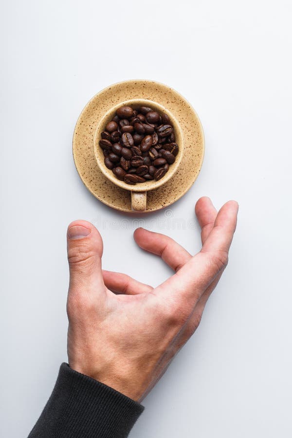 Hand Stretching To a Cup of Coffee on a White Background, Poured Stock ...