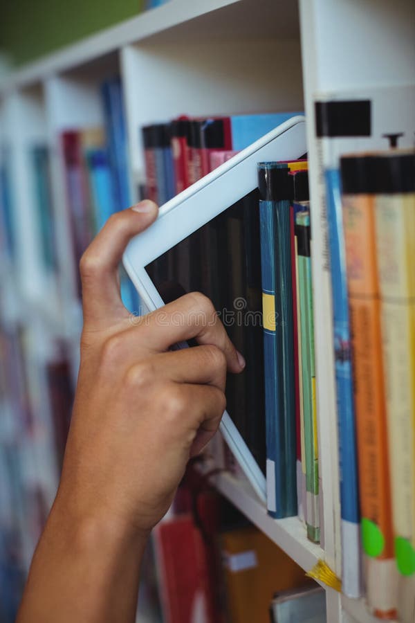 Hand of Student Keeping Digital Tablet in Bookshelf in Library Stock ...