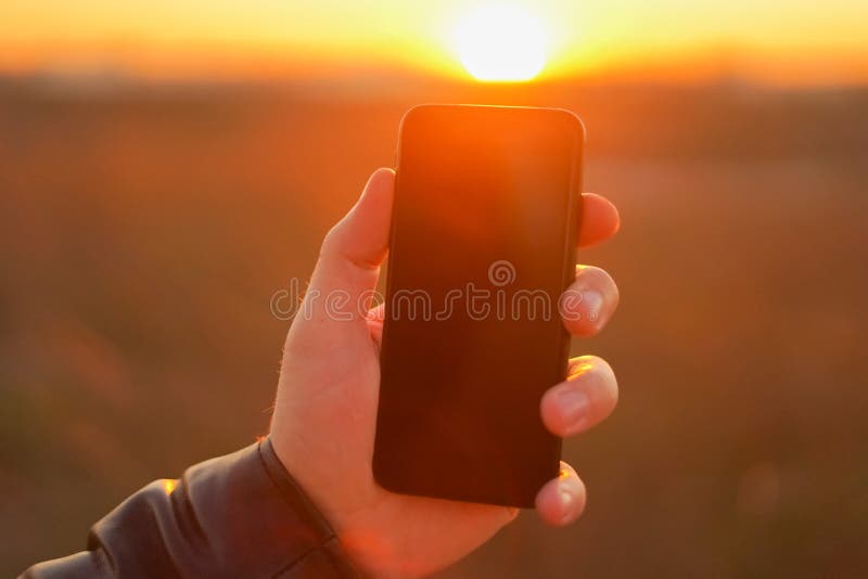 Hand in the Sun with a Phone Close-up Stock Photo - Image of internet ...