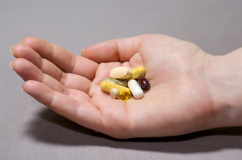 A Hand with Supplement Pills Stock Photo - Image of capsule, medicine ...