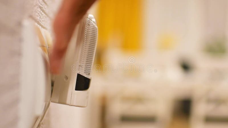Hand Switch on Light in Kitchen Room. Special Device Connects Power ...