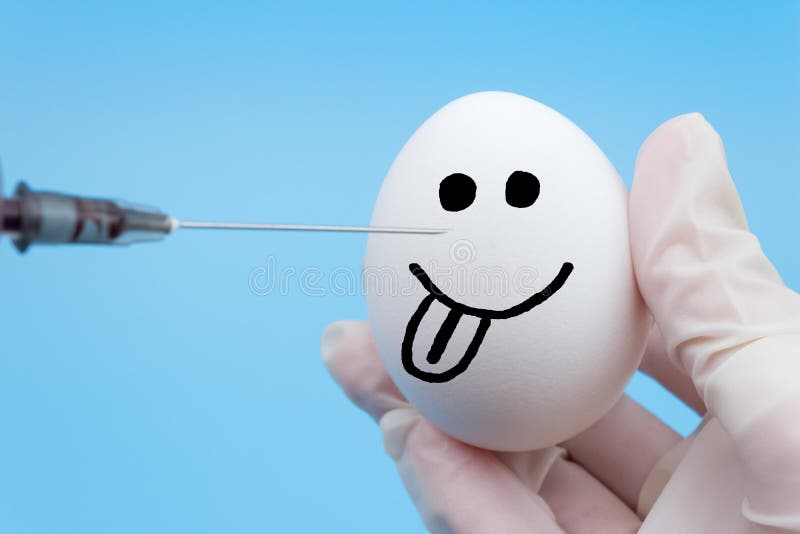 The Scientist Makes an Injection with a Syringe into the Egg Stock ...