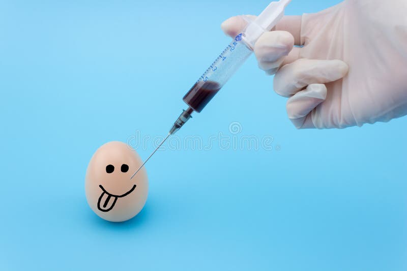 The Scientist Makes an Injection with a Syringe into the Egg Stock ...