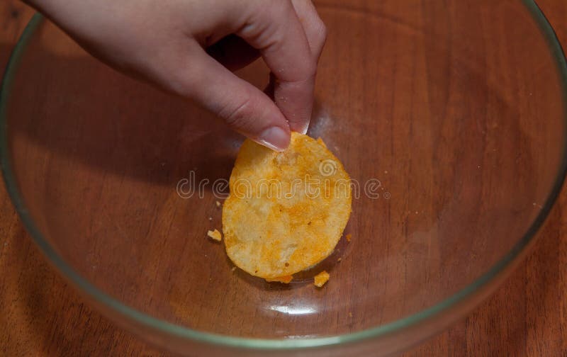 The Hand Takes the Chips in the Plate Stock Photo - Image of crunchy ...