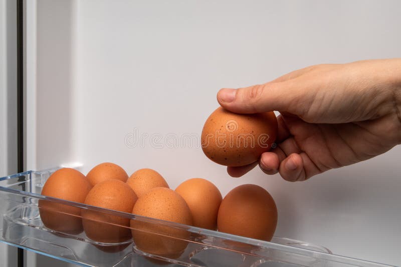 Hand Takes an Egg Out of the Fridge. Food and Storage Stock Photo ...