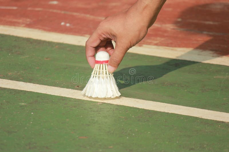 Hand takes the shuttlecock stock photo. Image of badminton - 272753342