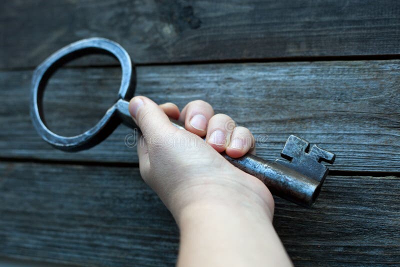 Hand Taking A Big Old Key From Wooden Table Stock Image - Image of ...