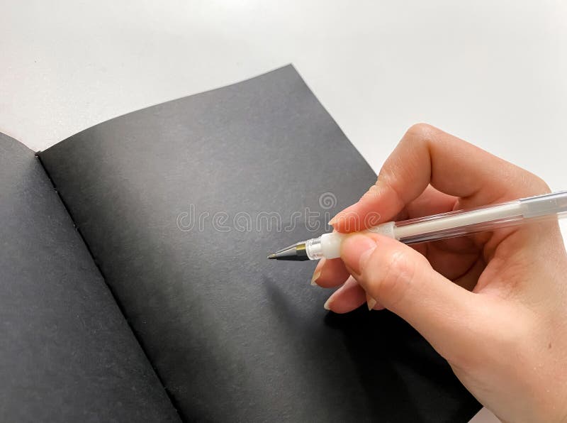 Hand Taking Notes in a Notebook with Black Sheets.Planning Concept ...