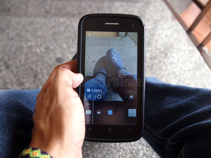 Hand Taking a Photo of Feet Using a Smartphone Stock Image - Image of ...