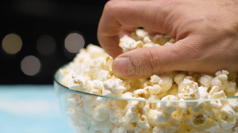 Hand taking popcorn stock image. Image of food, table - 197649589
