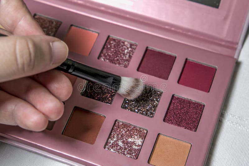 A Hand Taking Some Makeup Powder from a Different Color Makeup Palette ...