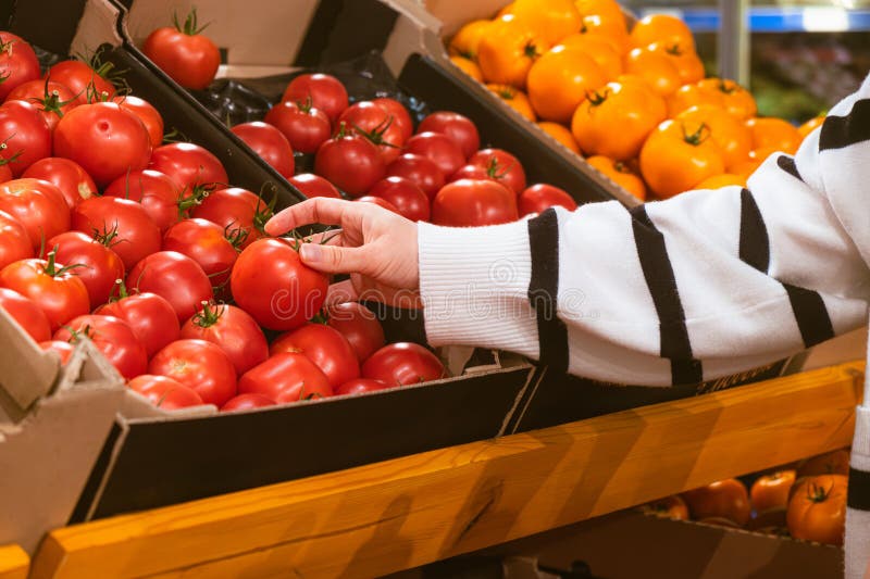 Hand Taking Tomatoes from Grocery Store Shelf Stock Photo - Image of ...