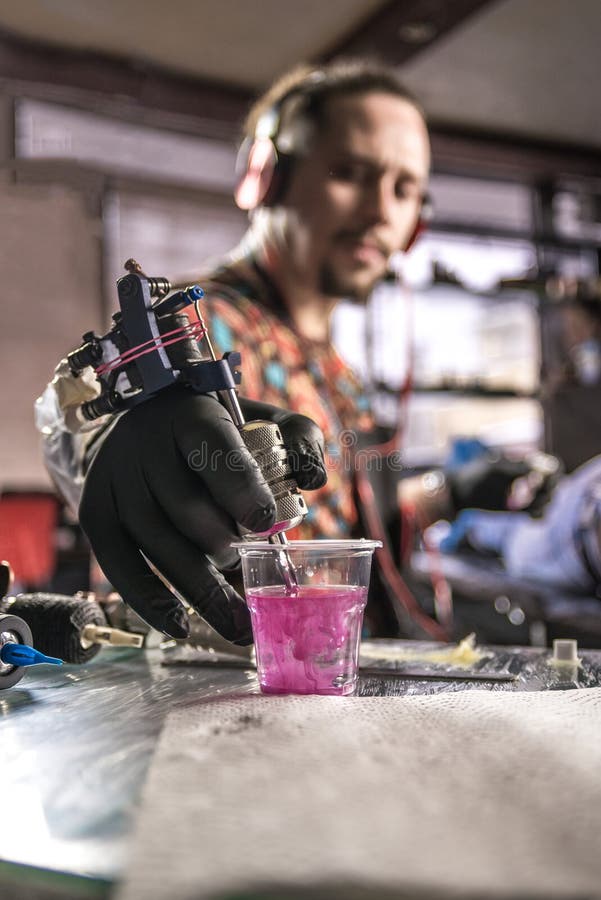 Hand of Tattoo Artist and a Tattoo Gun. Stock Image - Image of salon ... Hand of Tattoo Artist and a Tattoo Gun. Stock Image - Image of salon ...