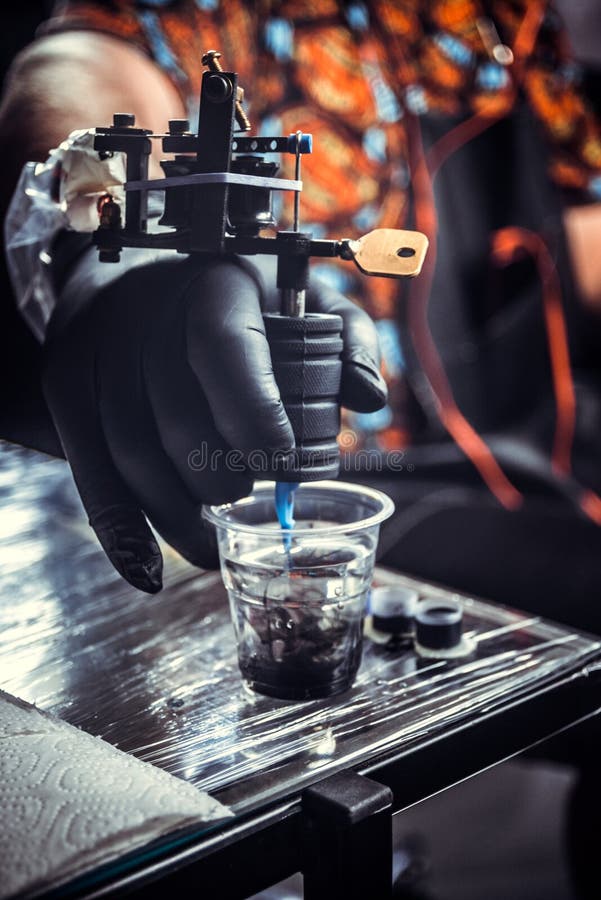Hand of Tattoo Artist with a Tattoo Gun. Stock Image - Image of tatoo ... Hand of Tattoo Artist with a Tattoo Gun. Stock Image - Image of tatoo ...