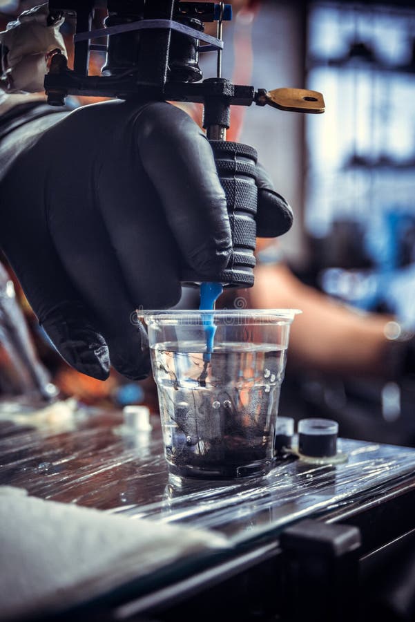 Hand of Tattoo Artist with a Tattoo Machine. Stock Image - Image of ... Hand of Tattoo Artist with a Tattoo Machine. Stock Image - Image of ...