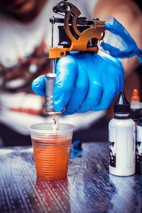 Hand of a Tattoo Specialist and a Tattoo Machine. Stock Photo - Image ...