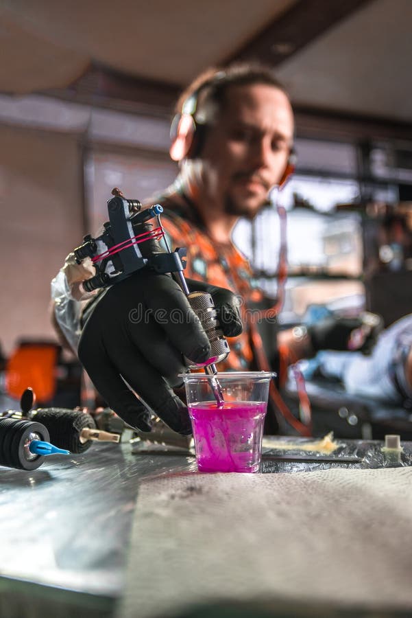 Hand of Tattooer with a Tattoo Machine. Stock Photo - Image of machine ...