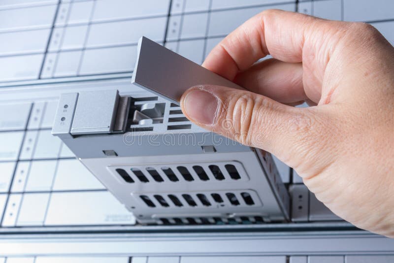 Hand of a Technician Exchanging Hard Drive with SAS Interface in Stock ...