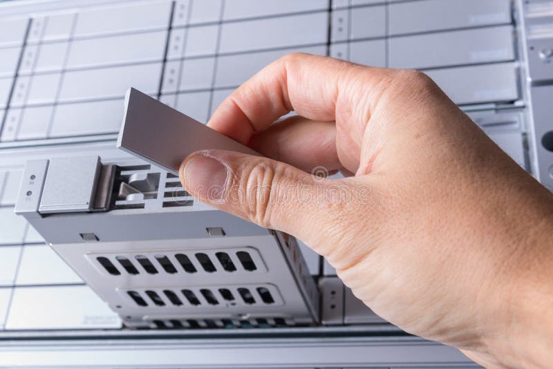 Hand of a Technician Exchanging Hard Drive with SAS Interface in Stock ...
