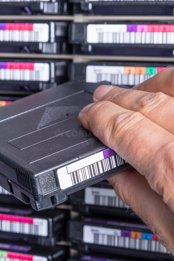 Hand of a Technician Holding Data Storage Magnetic Tape in Front Stock ...