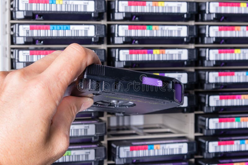 Hand of a Technician Holding Data Storage Magnetic Tape in Front Stock ...