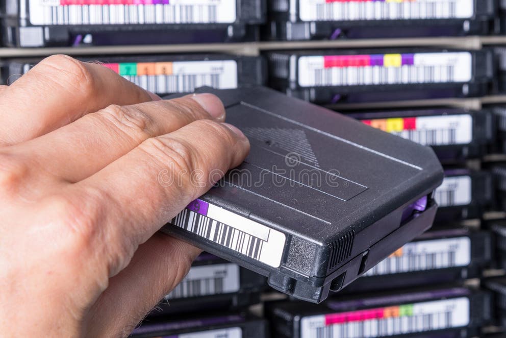 Hand of a Technician Holding Data Storage Magnetic Tape in Front Stock ...