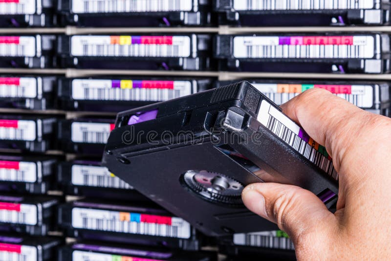 Hand of a Technician Holding Data Storage Magnetic Tape in Front Stock ...