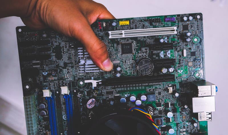 Hand of Technician Operator Assembling the CPU into Computer Mainboard ...