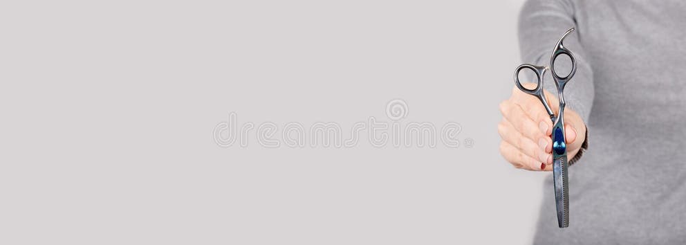 Hand with Thinning Scissors on Grey Background. Stock Image - Image of ...