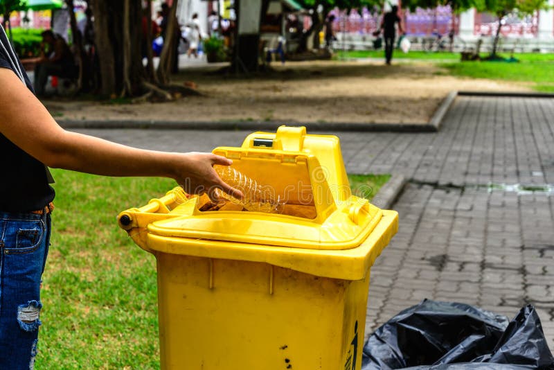 Hand Throwing Bottle in the Yellow Litter Bin Stock Photo - Image of ...