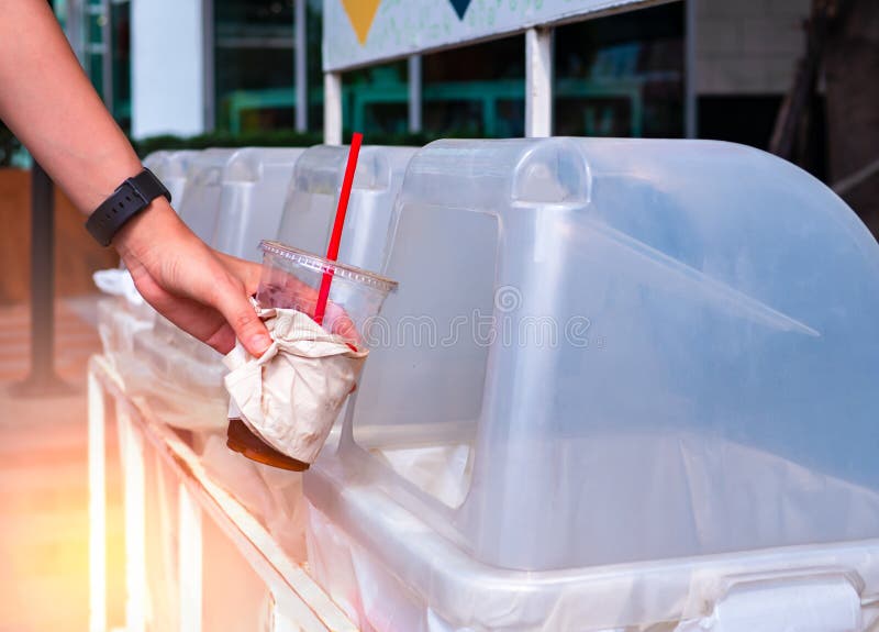 Hand Throwing Empty Plastic Coffee Cup into the Recycling Bin Stock ...