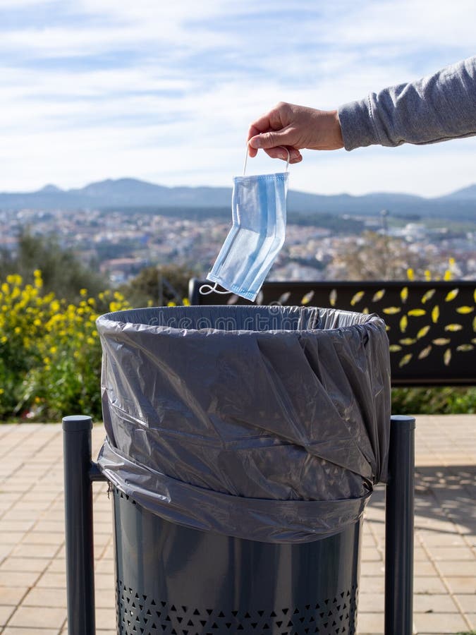 Hand Throwing a Face Mask into a Trash Garbage Can Stock Photo - Image ...