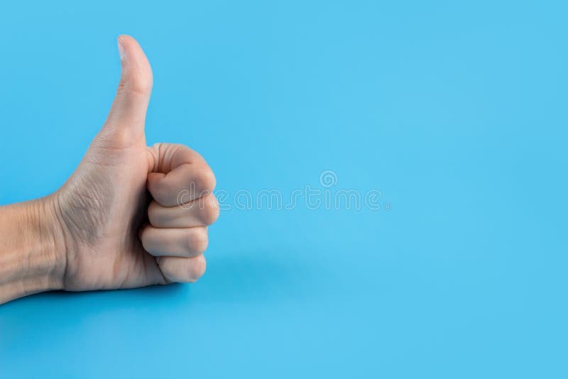 Hand with Thumbs Up on a Blue Background Close Up. Copy Space Stock ...