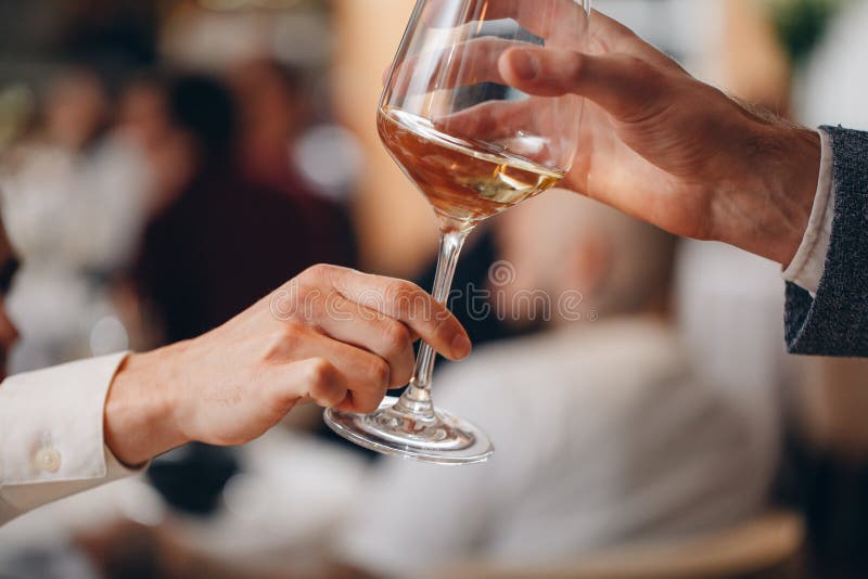 From Hand To Hand Pass a Beautiful Glass of White Wine at Dinner in a ...