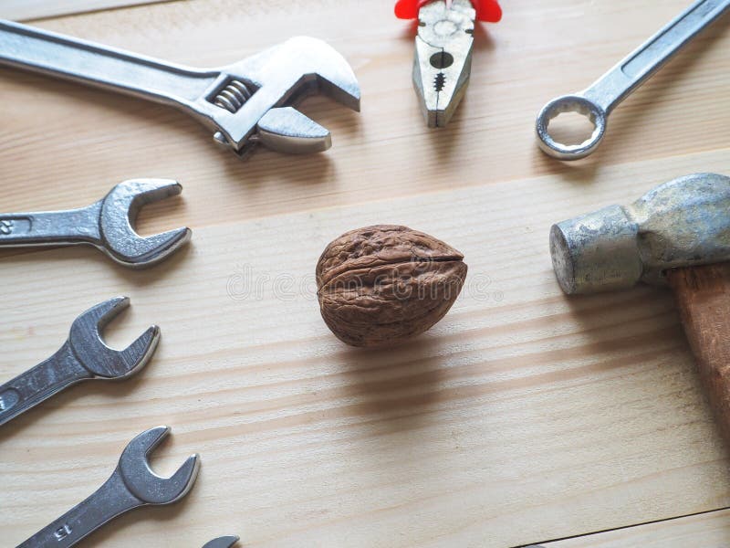 Hand, Tool and Big Walnut on Wooden Background. the Concept of Complex ...