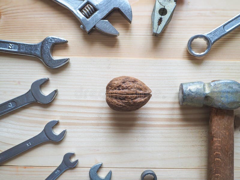 Hand, Tool and Big Walnut on Wooden Background. the Concept of Complex ...